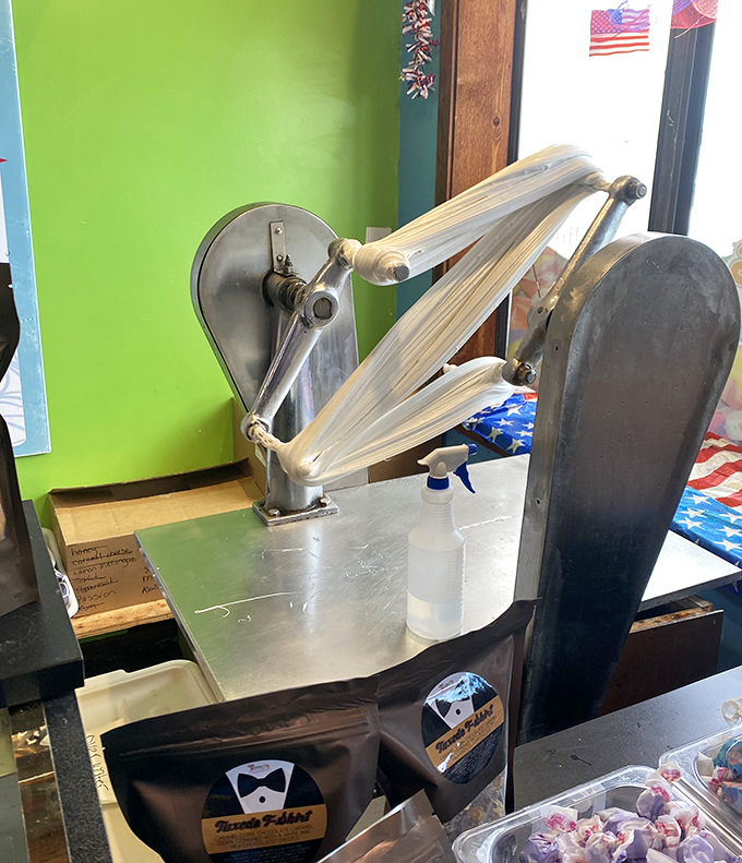 The taffy-pulling machine works its magic, stretching and folding sweetness into submission through a process that's mesmerizing to watch.