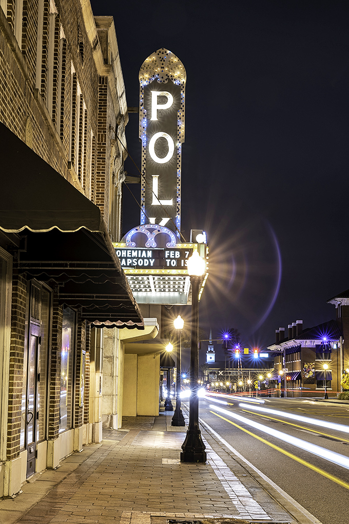 The Polk's vertical sign illuminates the night, a blue-white beacon that's been guiding entertainment seekers through downtown Lakeland for generations.