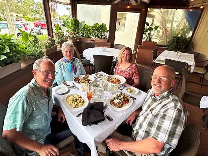 Happy diners enjoying their meals together, because great Italian food makes everyone smile like this.