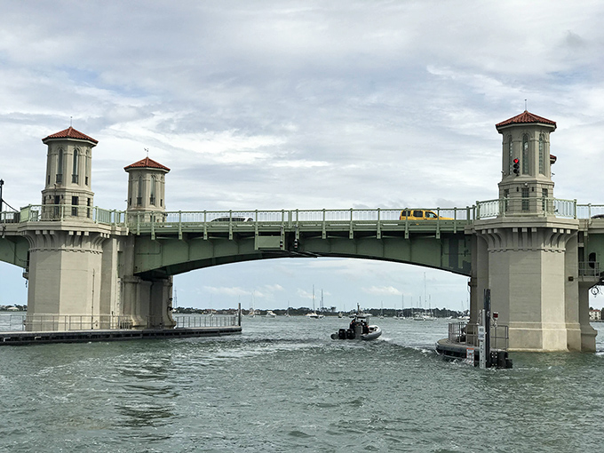 Boats pass through the open drawbridge, a daily reminder that in the battle between land and sea traffic, water always wins.