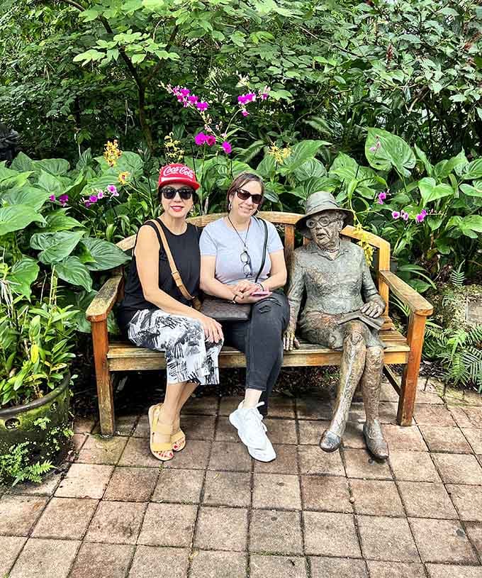 Visitors pose with a bronze sculpture, creating the kind of vacation photo that makes friends back home immediately jealous.