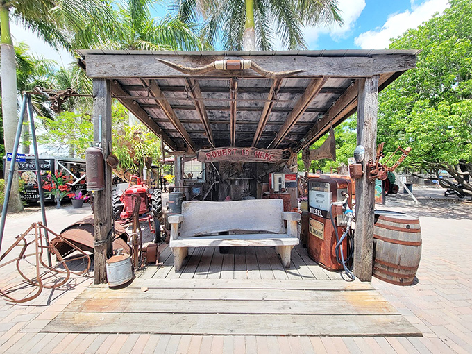 The perfect pit stop! This rustic bench nestled between vintage gas pumps offers weary visitors a moment to savor their exotic fruit milkshakes in nostalgic surroundings.