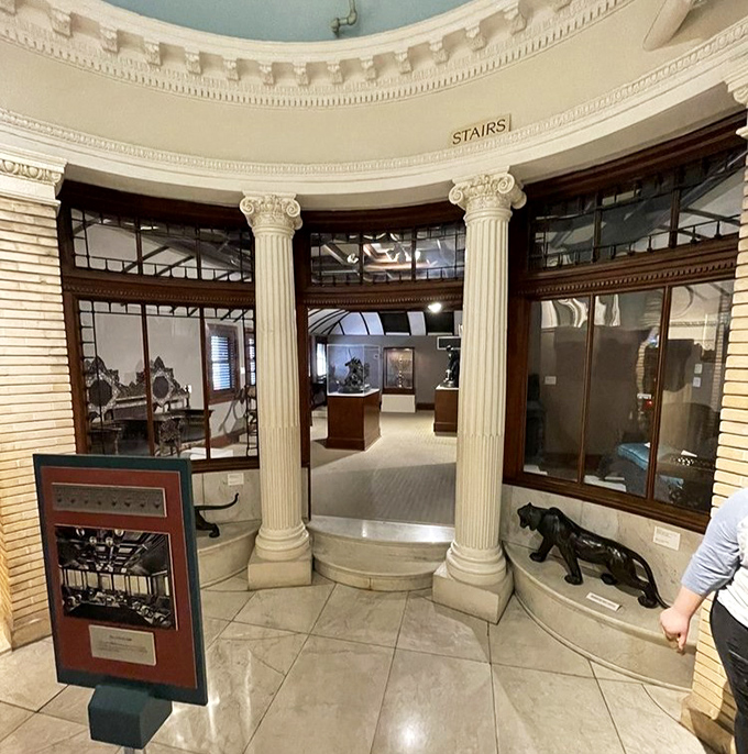 Classical columns frame the entrance to another gallery, inviting visitors deeper into the museum's labyrinth of historical treasures.