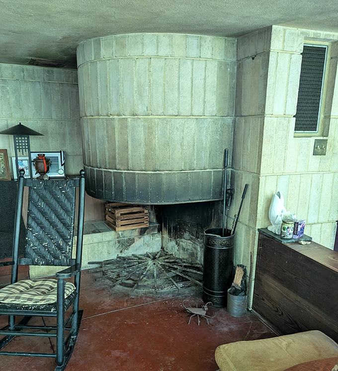 The massive fireplace anchors the living space like a primitive hearth, reminding us that Wright understood our primal connection to fire.