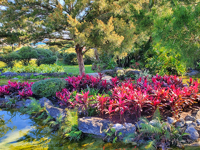 Nature's own masterpiece: vibrant tropical plants create a living rainbow that frames the already stunning spring waters.
