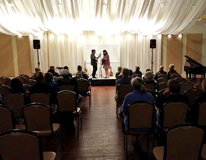 Intimate performances in the smaller venue create connection between artists and audience, the draped backdrop adding elegance to every note.