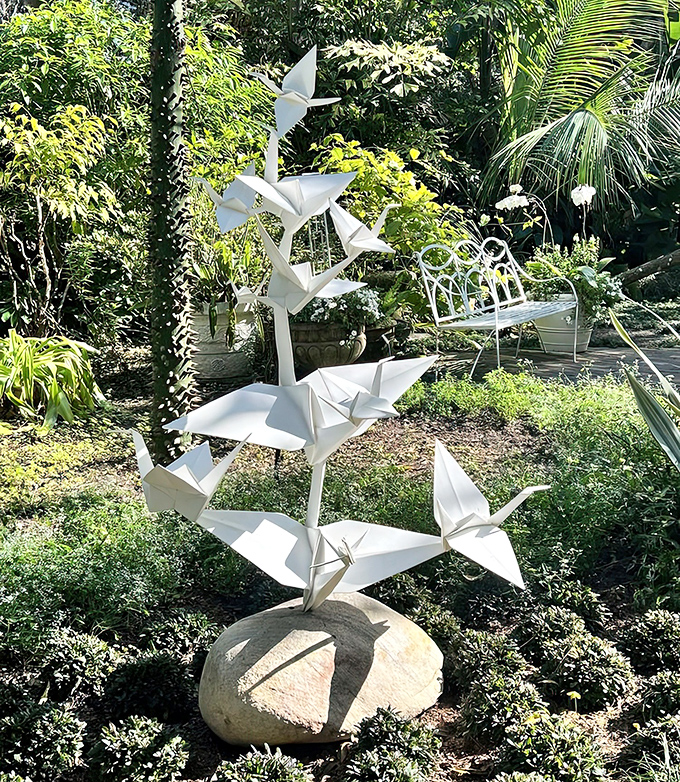 These origami-inspired metal cranes seem poised between flight and stillness – art capturing that magical in-between moment.