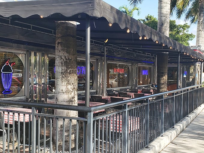 Outdoor seating creates a delightful contradiction &ndash; enjoying 1950s diner classics under swaying Florida palm trees and modern skies.