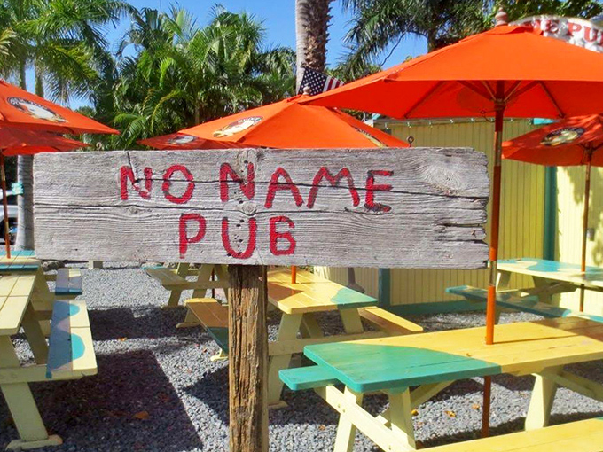 Picnic table paradise! These cheerful yellow and teal tables under bright orange umbrellas practically scream "Sit down and stay awhile!"
