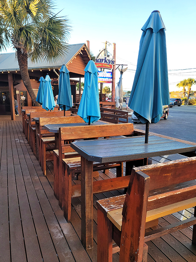 Rustic wooden tables and turquoise umbrellas create the perfect setting for alfresco dining with the Gulf of Mexico as your backdrop.