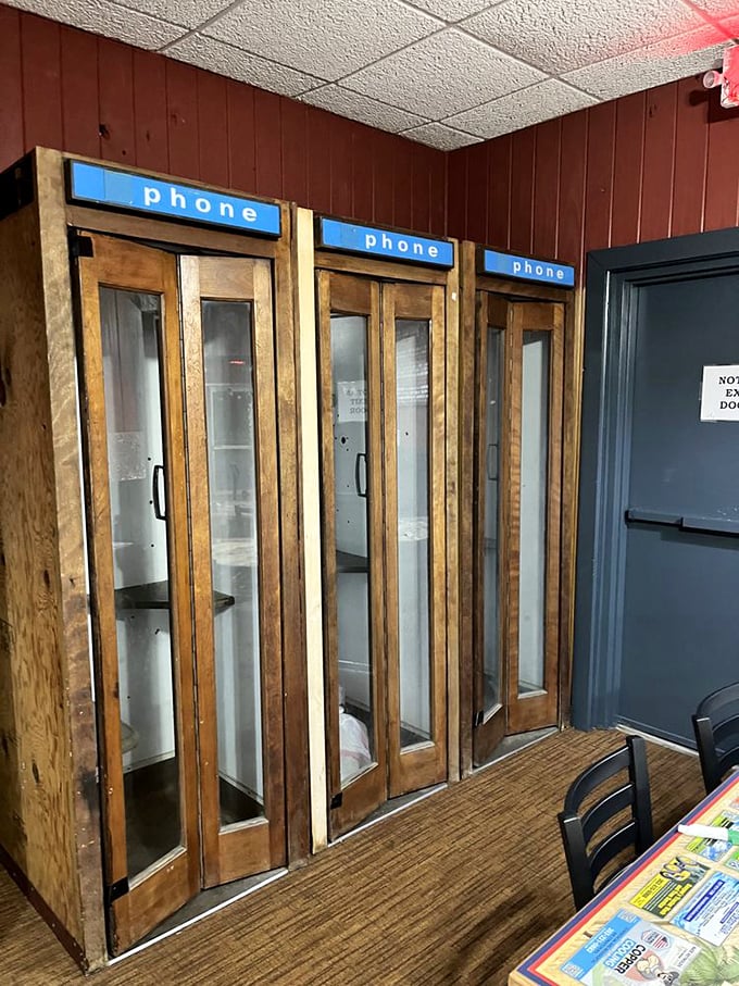 Vintage phone booths stand as charming relics from an era when "texting" meant passing notes in class and calls required actual quarters.