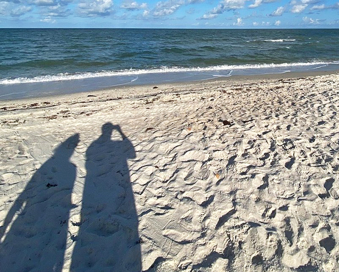 Shadows and shores: Long afternoon shadows stretch across untouched sand, where each footprint tells the story of a day well spent.