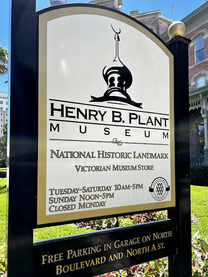 The Henry B. Plant Museum sign welcomes visitors to this National Historic Landmark, where Victorian splendor awaits just beyond the manicured gardens.