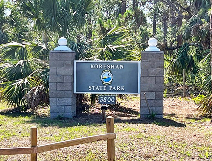The park's entrance sign stands as a portal between worlds &ndash; step through and trade modern chaos for historical wonder.