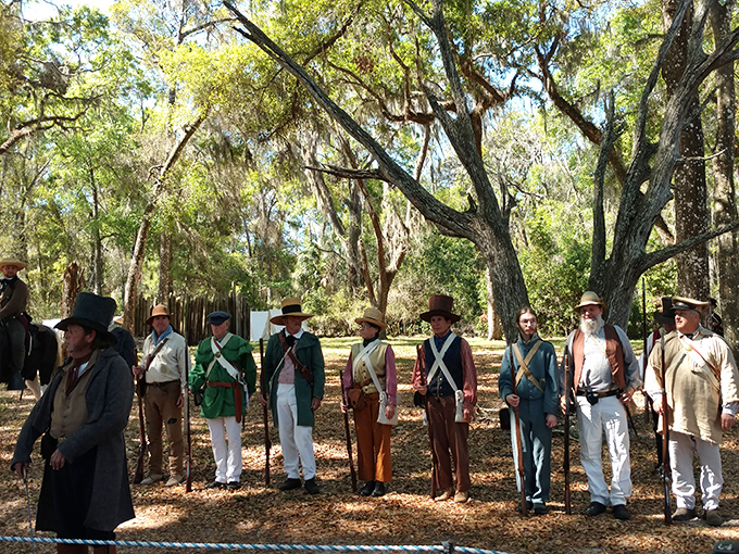 Colorfully uniformed reenactors stand at attention, their diverse regalia representing the complex tapestry of Florida's military history.