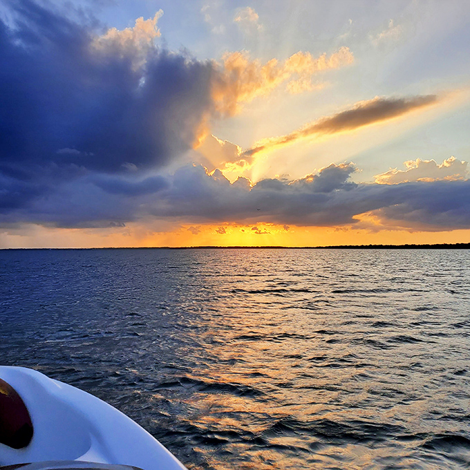 The day's grand finale paints East Lake Toho in impossible colors, turning an ordinary boat ride into a journey through liquid fire.