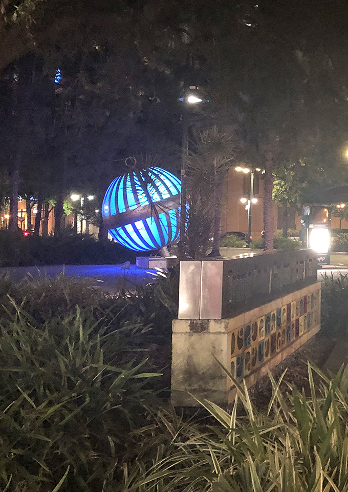 As evening approaches, the sculpture begins to glow, creating a pocket of blue tranquility amid the urban energy of downtown.