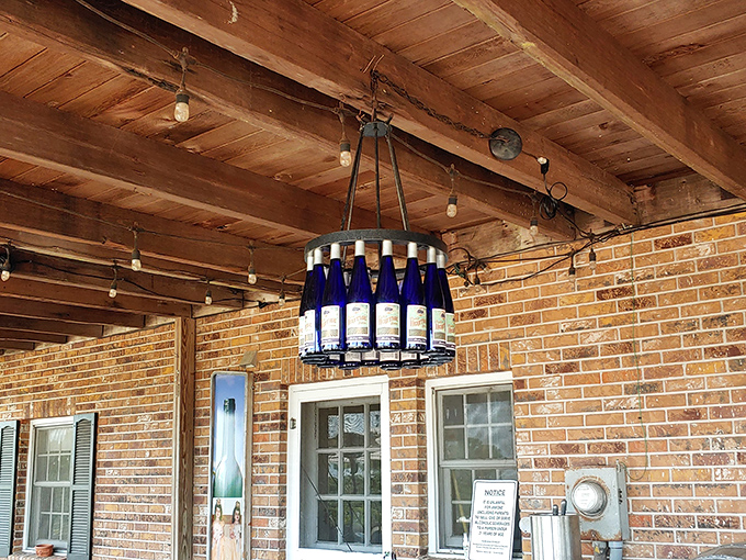 Ingenious lighting made from repurposed wine bottles illuminates the covered porch, showcasing the winery's creative approach to sustainability.