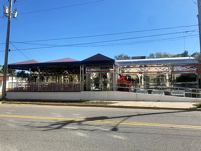 The stainless steel exterior of Georgie's Diner reflects clouds and palm trees, a vintage dining car that found its forever home in historic St. Augustine.