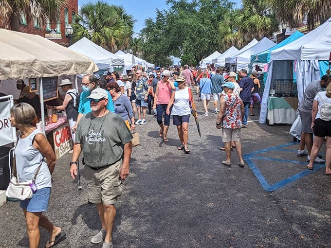 Visitors stroll past vendor tents at the Isle of Eight Flags Shrimp Festival, where seafood and art take over Fernandina Beach's historic downtown.