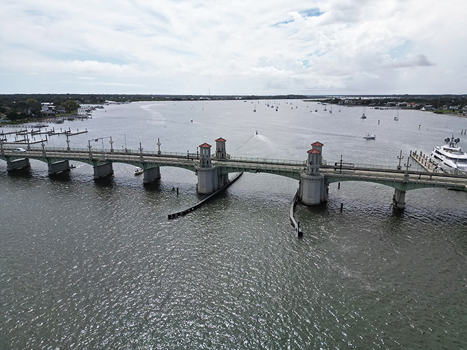 From above, the bridge creates a graceful curve across the water, connecting mainland to island like a stone necklace.