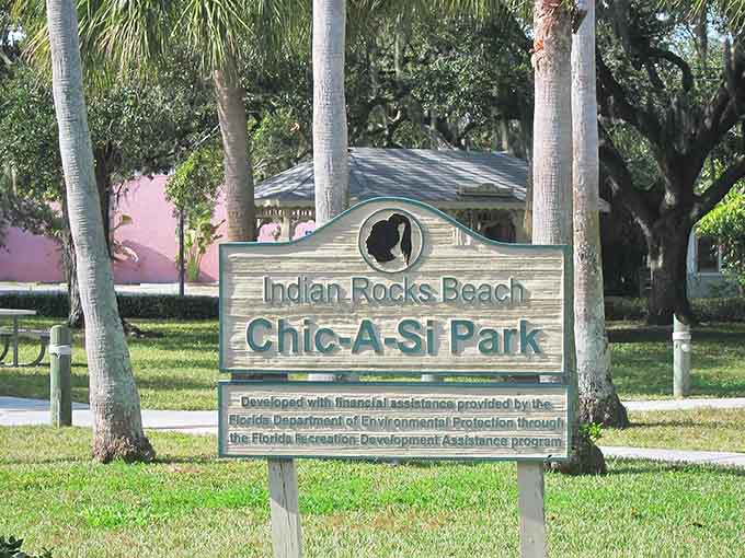 The park's sign stands proudly among native vegetation, marking the entrance to a place where past and present coexist in peaceful harmony.