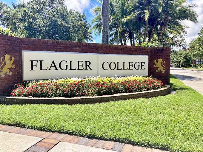 The college entrance sign offers a modest introduction to the architectural extravaganza waiting just beyond the flowering welcome.