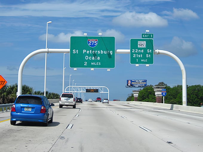 Green highway signs guide travelers through Florida's landscape, some leading to beaches and theme parks, others to places where history haunts the present.