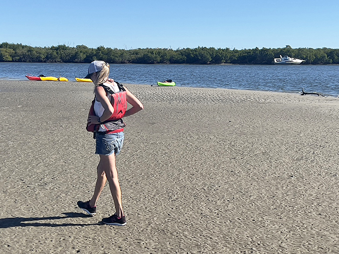 A peaceful moment on the shoreline, where the boundary between land and water blurs into the perfect launching point for bioluminescent adventures.