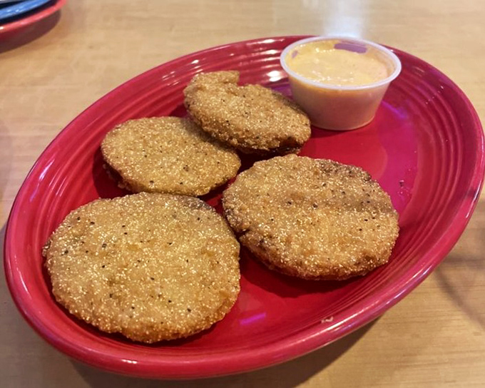 Fried Green Tomatoes – tangy slices in crispy cornmeal jackets, served with a dipping sauce that makes you wonder why you don't order these everywhere.