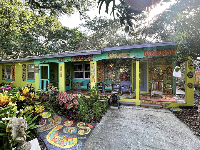 The front view reveals a cottage that refuses to blend in, wearing its artistic heart on every exterior surface like a badge of colorful courage.