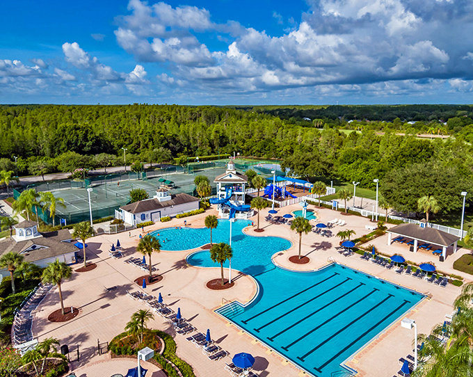 Heritage Harbor Club House: Resort-style relaxation beckons at this aquatic oasis where palm trees stand sentinel over crystal blue waters.