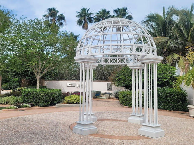 This elegant gazebo provides shelter and a gathering spot, its classic design adding a touch of formal beauty to the garden's playful, interactive landscape.