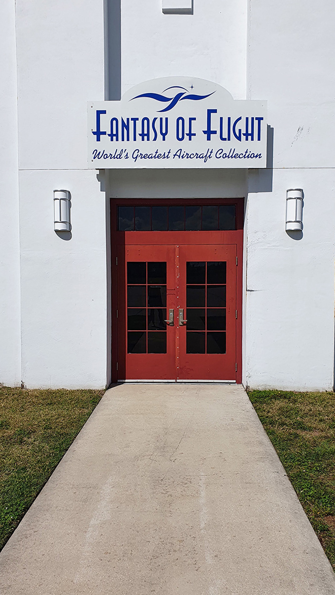 The museum's entrance welcomes aviation enthusiasts with its bold "Fantasy of Flight" sign, promising adventures through time and sky beyond those red doors.