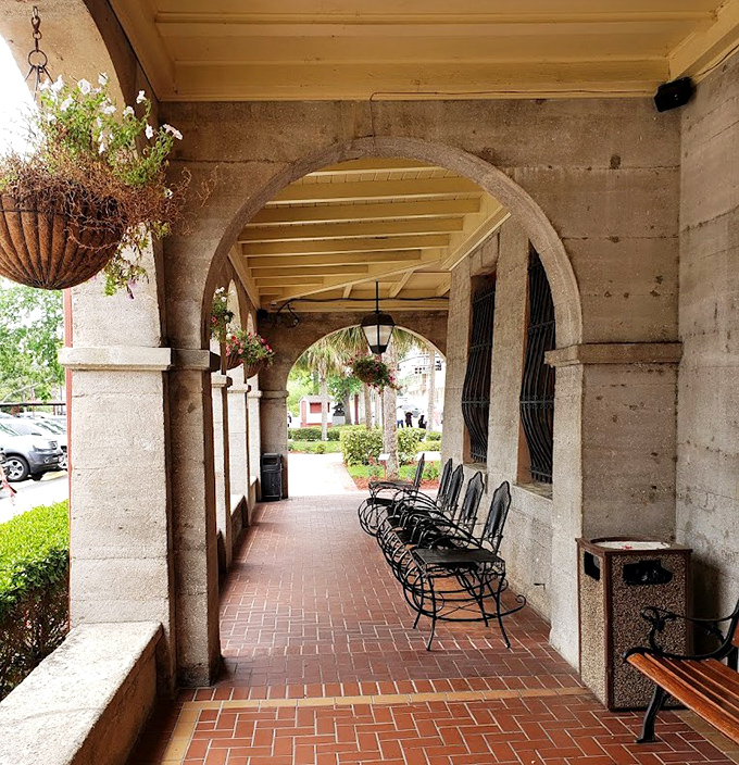 Arched colonnades offer shaded respite and framed views of the gardens, their elegant curves softening the fortress-like architecture.