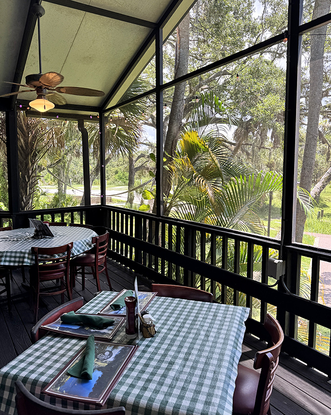 The screened porch offers front-row seats to Florida's natural beauty, where river views complement every bite and sip.