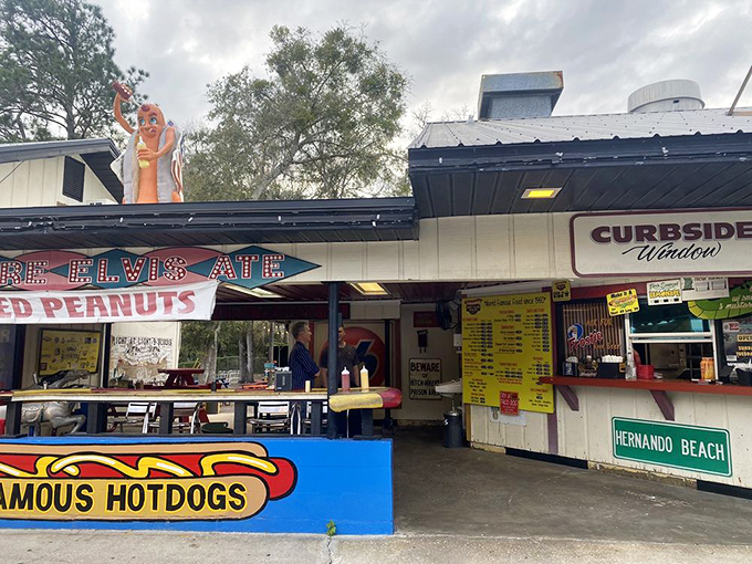 The outdoor setting welcomes hungry travelers with its cheerful hot dog mascot and curbside service window &ndash; a true Florida roadside classic.