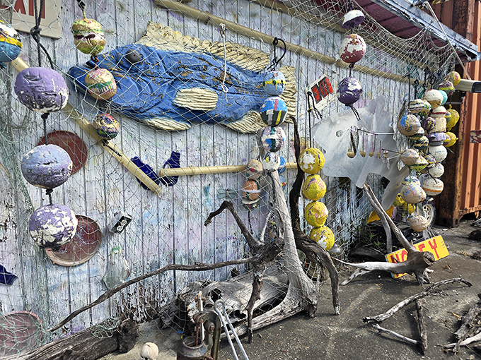 Painted buoys dangle like strange fruit from a maritime tree, each one a colorful testament to creative recycling and coastal aesthetics.