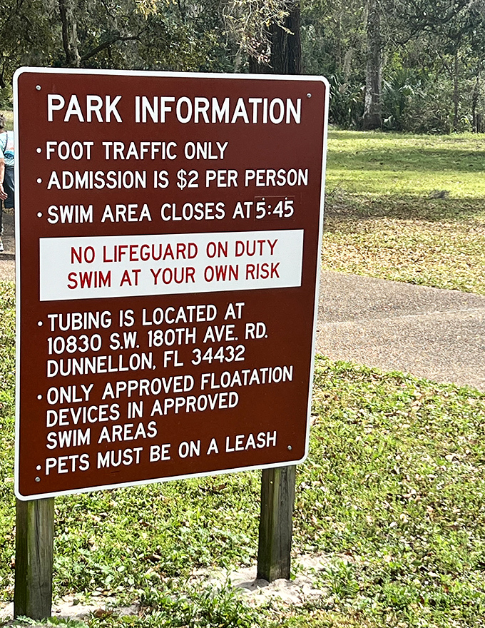 Park information signs lay out the rules and admission details, because even paradise needs some guidelines to keep it from turning into chaos, though these seem pretty reasonable all things considered.