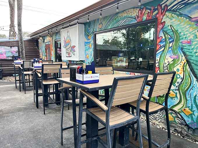 Outdoor seating with vibrant murals and umbrella-shaded tables makes every meal feel like a mini vacation, even on your lunch break from work.