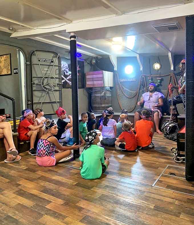 A captivated audience of young pirates hangs on every word as crew members share tales of treasure and adventure in authentic pirate fashion.
