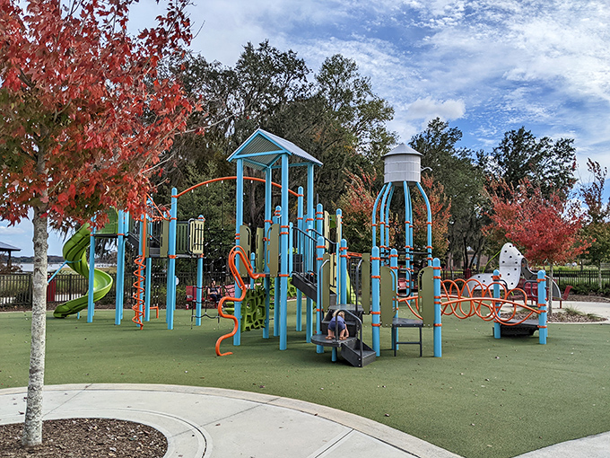 Playground: Colorful equipment invites little adventurers to climb and slide while parents enjoy a moment of peace in this lakeside setting.