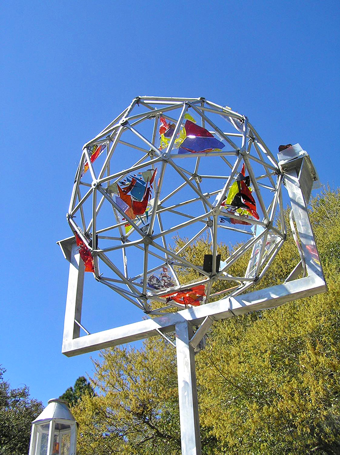 A geodesic sphere made of metal framework and colored glass panels catches the sunlight, creating another dimension to this celebration of creative recycling.