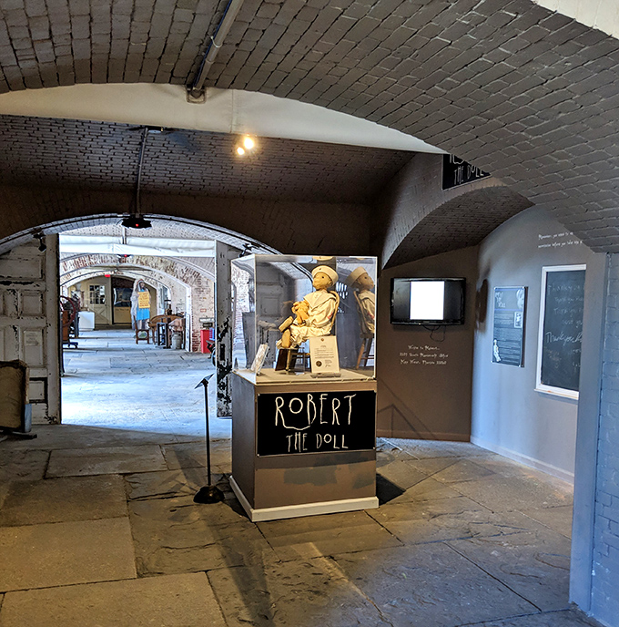 Robert the Doll sits in judgmental silence, his glass case doing little to contain his legendary influence over visitors.