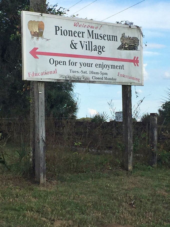 The roadside sign points visitors toward both education and entertainment, promising a journey through Florida's formative years.