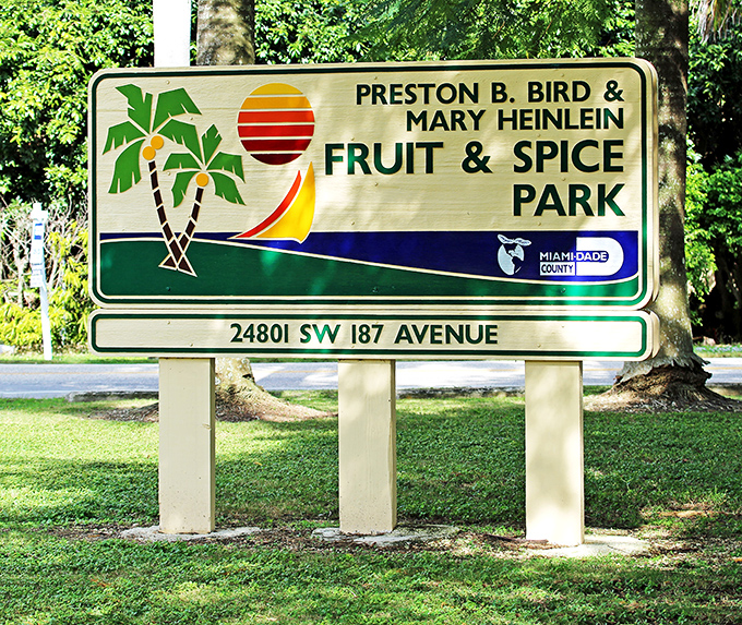 The colorful park sign stands as a cheerful sentinel, promising tropical delights just beyond the entrance.