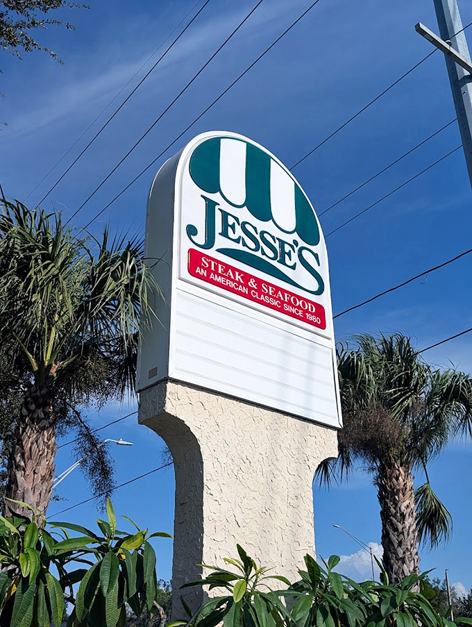 The roadside sign stands tall among palm trees, a landmark for locals and a discovery waiting to happen for lucky travelers.