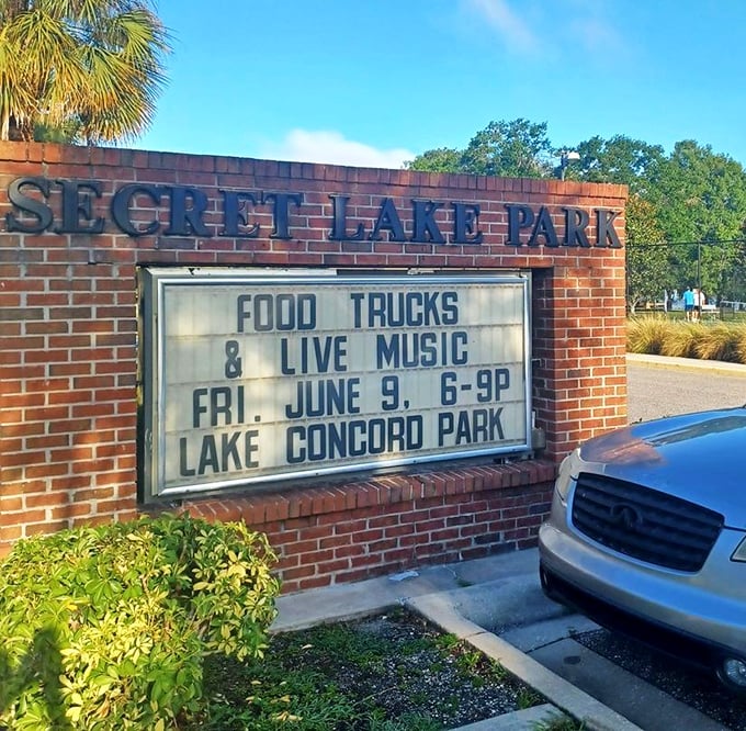The park's entrance sign announces upcoming events, proving that "secret" places often host the best community gatherings.