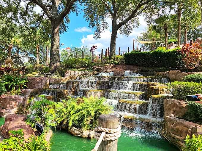 Nature's own water feature cascades down multiple rock tiers, creating both a stunning visual centerpiece and the soothing soundtrack to your putting adventure.