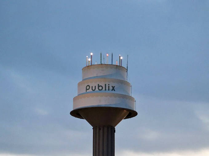 As darkness falls, the "candles" atop the cake illuminate, creating a perpetual birthday celebration visible for miles around Lakeland.